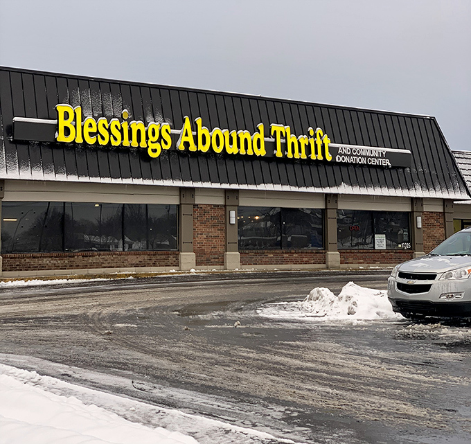 The bright yellow sign beckons like a budget-friendly lighthouse, guiding bargain hunters to shores of affordable treasures in Overland Park.