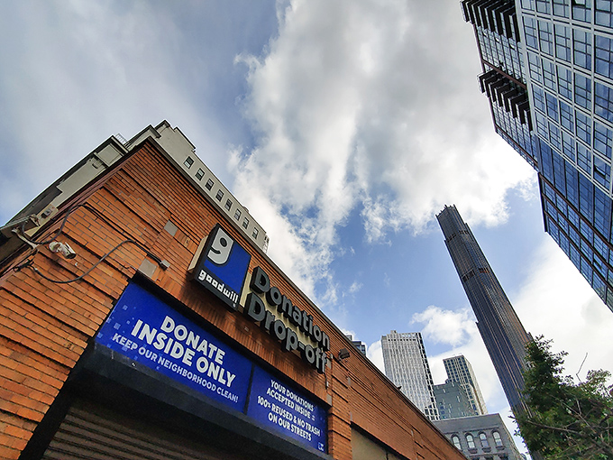 The brick facade of Brooklyn's Goodwill welcomes bargain hunters like a treasure chest waiting to be opened, promising affordable finds behind its glass doors.