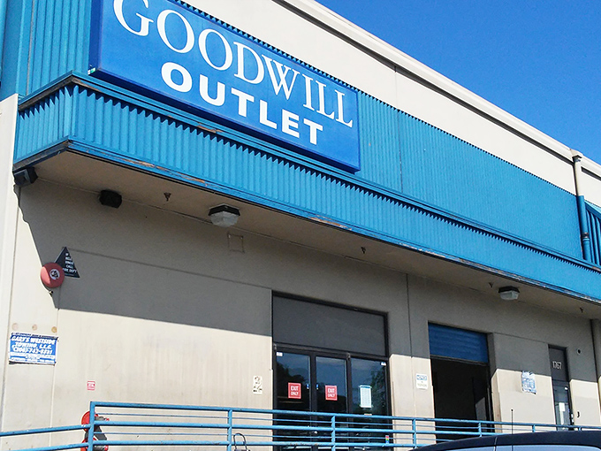 The blue-trimmed exterior of Seattle Outlet Goodwill stands like a portal to bargain dimension&mdash;where treasures await those brave enough to enter. 