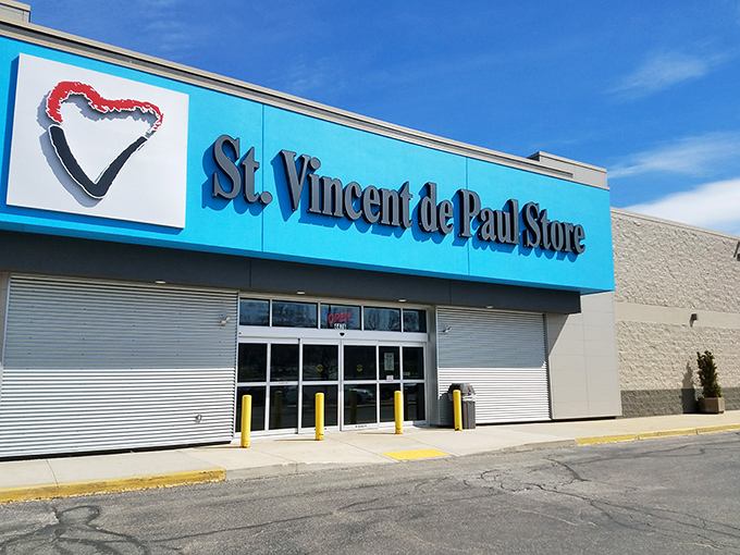 The bright blue sign of St. Vincent de Paul stands like a beacon for bargain hunters against Wisconsin's changeable skies. Treasure awaits inside!