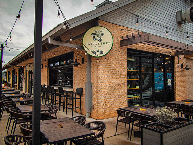 Modern farmhouse meets culinary playground at Cattle Shed's inviting exterior. String lights and comfortable outdoor seating promise evenings of beef-centric bliss in Alpharetta.