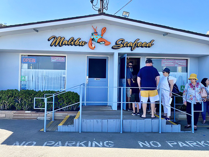 The unassuming white building with its cheerful red trim might not scream "culinary destination," but locals know this seafood shack holds treasures that would make Neptune himself line up.