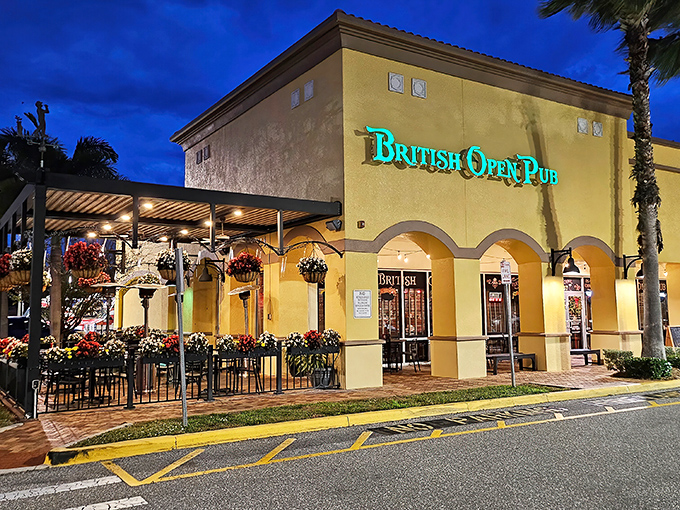 A slice of Britain basks in Florida sunshine. The British Open Pub's cheerful yellow exterior and teal signage create an inviting cultural crossroads where palm trees meet pub tradition.