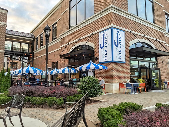 The brick fa&ccedil;ade of Big B's Fish Joint welcomes seafood lovers with its distinctive blue and white signage and inviting patio umbrellas.