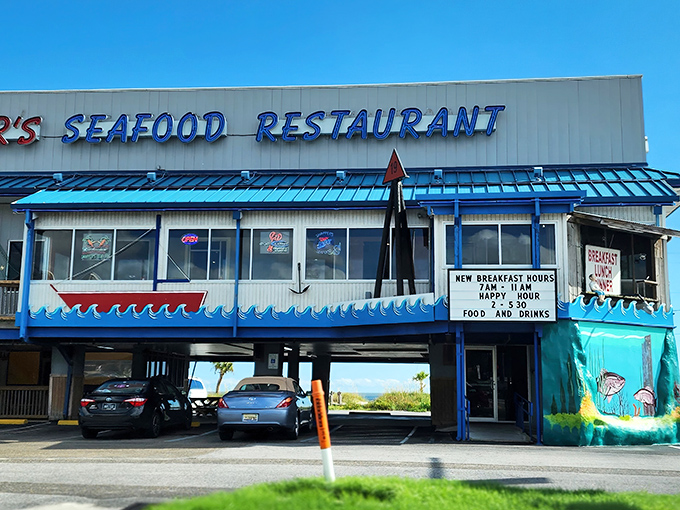 Snapper's iconic blue-trimmed exterior stands like a beacon for seafood lovers, with parking cleverly tucked underneath&mdash;Gulf Coast practicality at its finest.