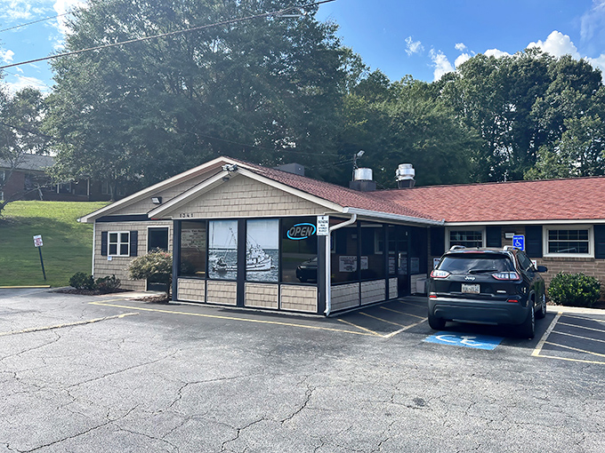 Unassuming culinary treasures often hide in plain sight. This modest brick building in Dallas, NC houses seafood magic that would make coastal restaurants envious.