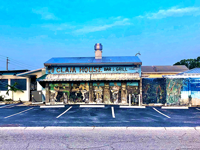 The unassuming blue-roofed exterior of The Clam House stands like a seafood speakeasy, promising treasures within that no fancy facade could improve upon.