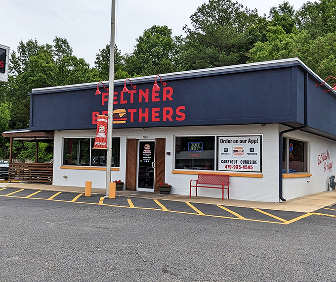 The red and black signage stands like a beacon of burger hope against the Arkansas sky. Simple, straightforward, and promising delicious things inside.