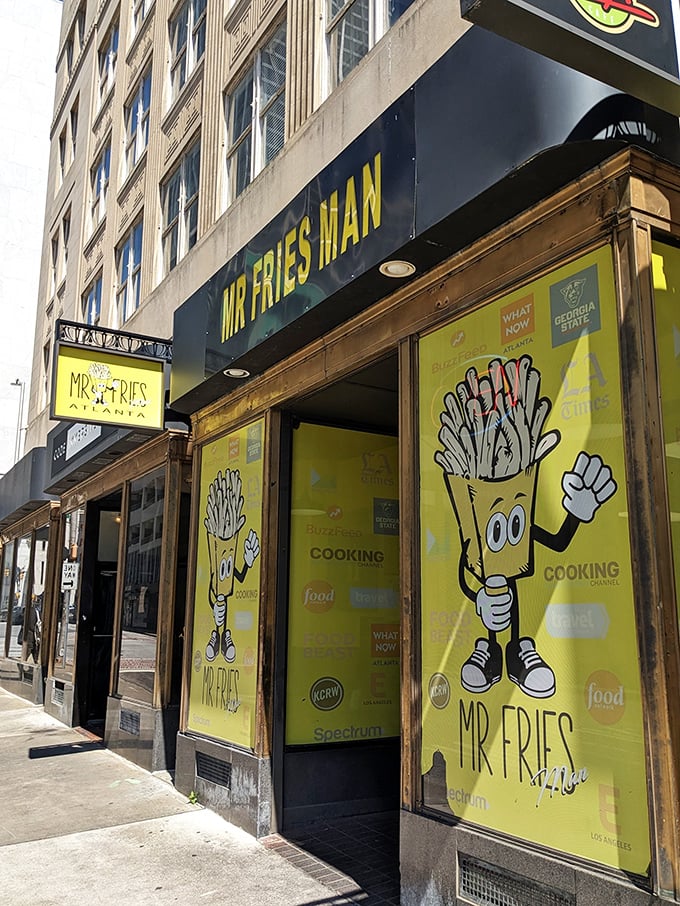 The bright yellow storefront stands out like a beacon of potato promise, with the cartoon fry mascot practically waving you inside.