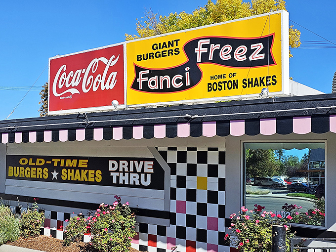 The checkered facade of Fanci Freez stands like a time portal to simpler days, when drive-thrus were social hubs and calories weren't counted, just savored. 