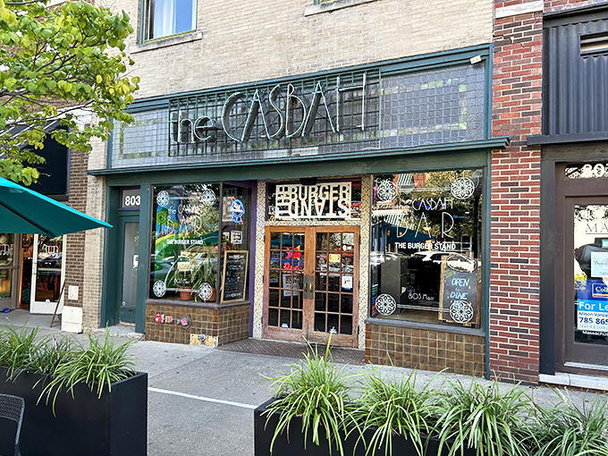 The tiled facade of The Casbah beckons like a culinary oasis on Massachusetts Street, promising burger nirvana behind those wooden doors.