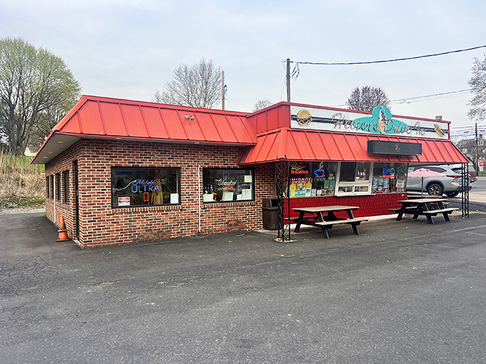 Twilight transforms this humble brick building into a beacon of comfort food promise. The red roof glows like a dinner bell calling hungry travelers home.