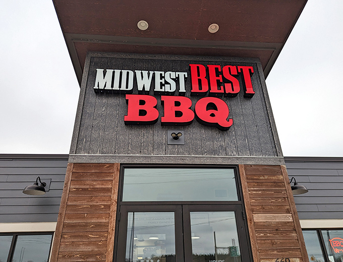 The bold red lettering against dark wood siding isn't just signage&mdash;it's a beacon for barbecue pilgrims seeking smoky salvation in Loveland.