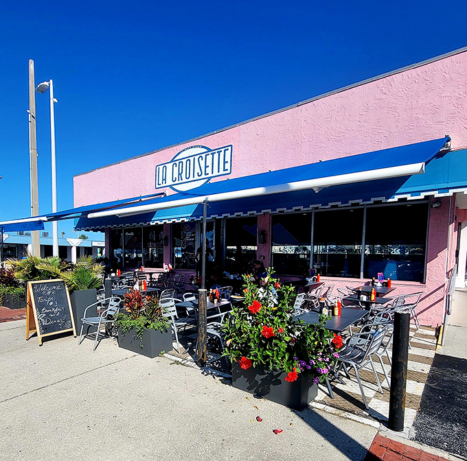 La Croisette's cheerful pink exterior with blue awnings stands out like a French postcard come to life on St. Pete Beach.