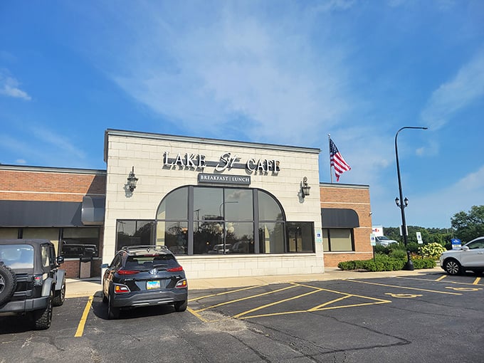 An unassuming strip mall storefront that proves culinary treasures don't always hide in fancy buildings. The American flag stands guard over breakfast paradise.