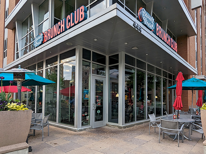 The corner entrance beckons like a brunch lighthouse, with those turquoise umbrellas promising a colorful escape from ordinary breakfast routines.