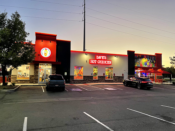 Dave's Hot Chicken's vibrant exterior is like a beacon for spice-seekers, with its bold red signage and eye-catching murals promising a flavor adventure inside.