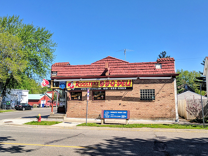 The iconic red exterior of Rooster's BBQ Deli stands like a beacon to hungry Minnesotans, complete with its blue ribbon of approval and cartoon mascot.