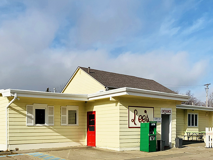 The iconic rooster stands sentinel atop its red pole, beckoning hungry travelers to this unassuming temple of fried chicken perfection in Lincoln.