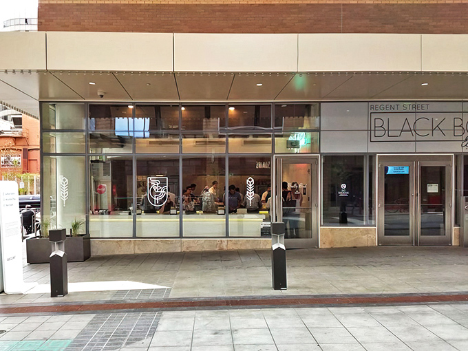 The "BAWK APPETIT HERE" sign says it all&mdash;Pretty Bird's storefront promises chicken nirvana with a side of clever wordplay.