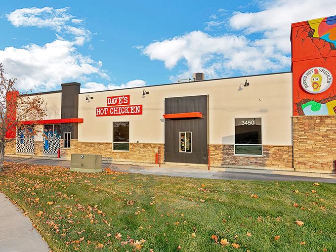 Dave's Hot Chicken's vibrant exterior is like a beacon for spice-seekers, with its bold red signage and eye-catching murals promising a flavor adventure inside.