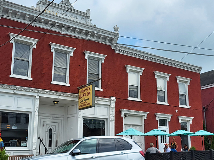 The stately red brick exterior of Wagner's Village Inn stands as a beacon of culinary tradition in Oldenburg, complete with a welcoming rooster sentinel.