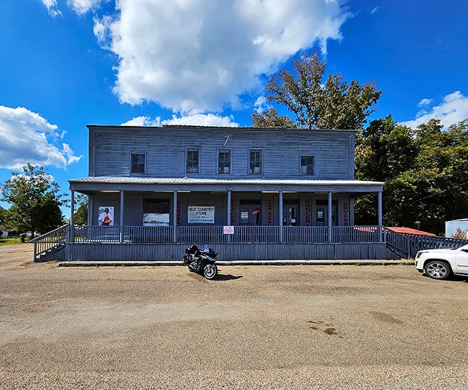 The weathered white clapboard exterior of The Old Country Store stands as a time capsule on Highway 61, promising culinary treasures within its humble walls.