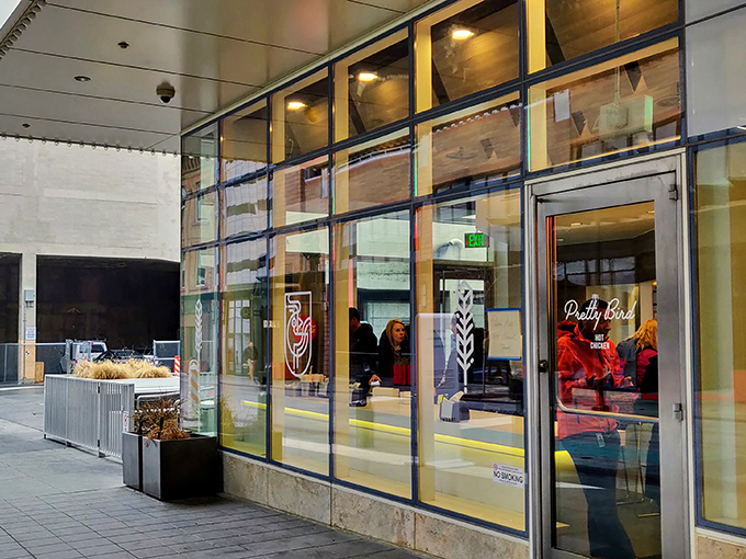 The "BAWK APPETIT HERE" sign says it all&mdash;Pretty Bird's storefront promises chicken nirvana with a side of clever wordplay.
