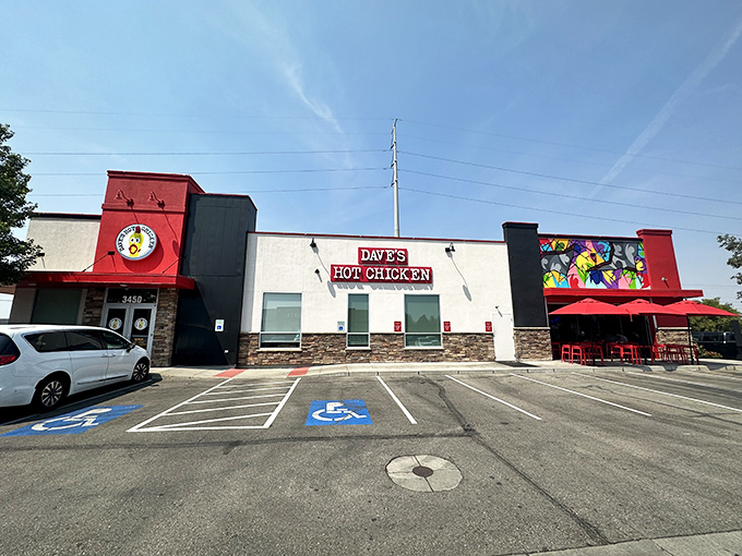 Dave's Hot Chicken's vibrant exterior is like a beacon for spice-seekers, with its bold red signage and eye-catching murals promising a flavor adventure inside.