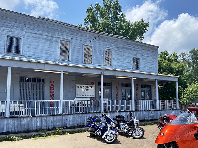The weathered white clapboard exterior of The Old Country Store stands as a time capsule on Highway 61, promising culinary treasures within its humble walls.