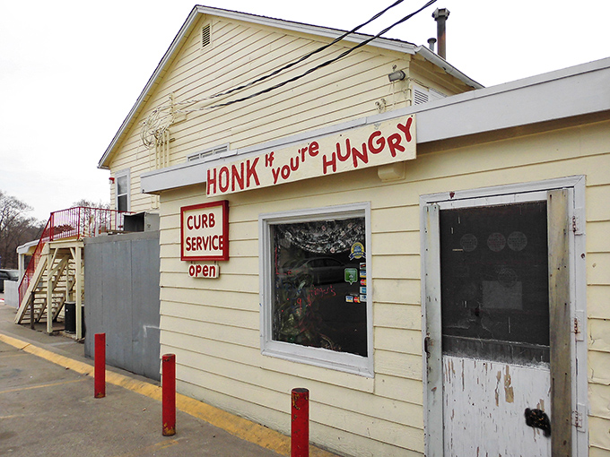 The iconic rooster stands sentinel atop its red pole, beckoning hungry travelers to this unassuming temple of fried chicken perfection in Lincoln.