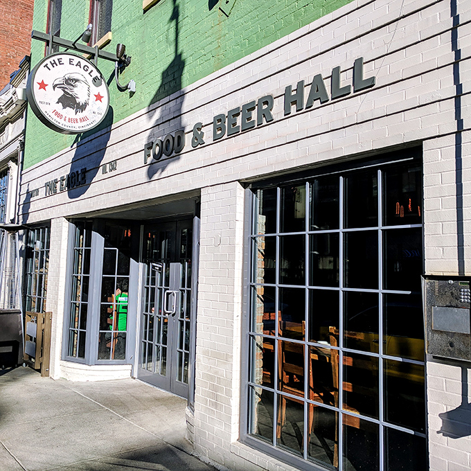The mint-green facade of The Eagle OTR stands out like a culinary beacon on Vine Street, promising Southern comfort in Cincinnati's historic district.