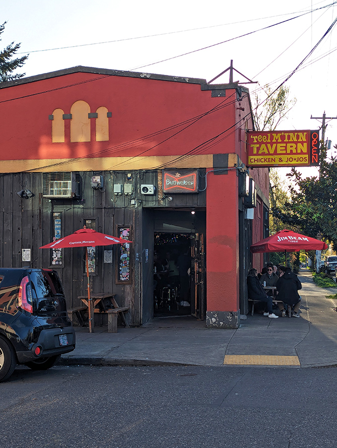 The red exterior of Reel M Inn stands like a defiant time capsule on SE Division Street, promising chicken worth waiting for behind that weathered facade.