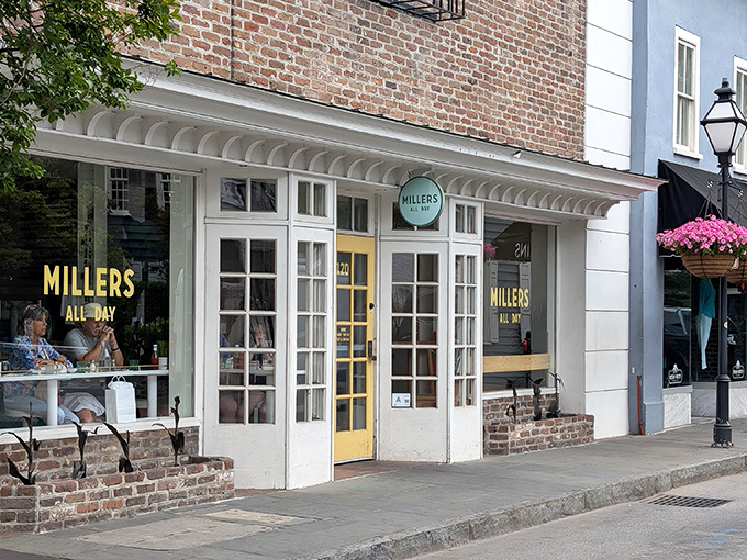 The charming storefront of Millers All Day beckons with its classic brick exterior and cheerful yellow door&mdash;like Charleston itself, both elegant and welcoming.