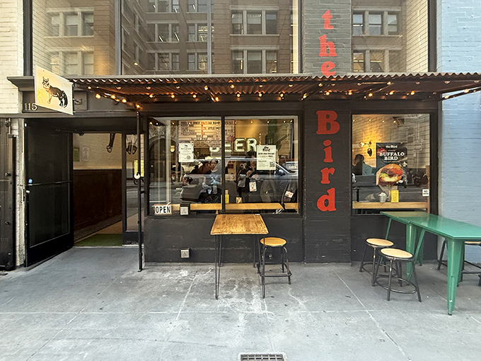 The bold red letters against the black storefront announce "the Bird" with no fanfare - just a promise of poultry perfection waiting inside.