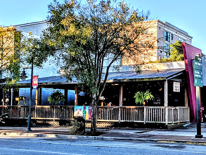 The welcoming front porch at Pawleys beckons like an old friend, promising cold drinks and burger bliss in Columbia's Five Points district.