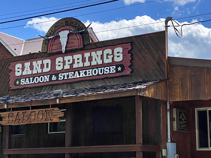 The Wild West meets Western Maryland at Sand Springs Saloon & Steakhouse, where the rustic wooden exterior promises carnivorous adventures within.
