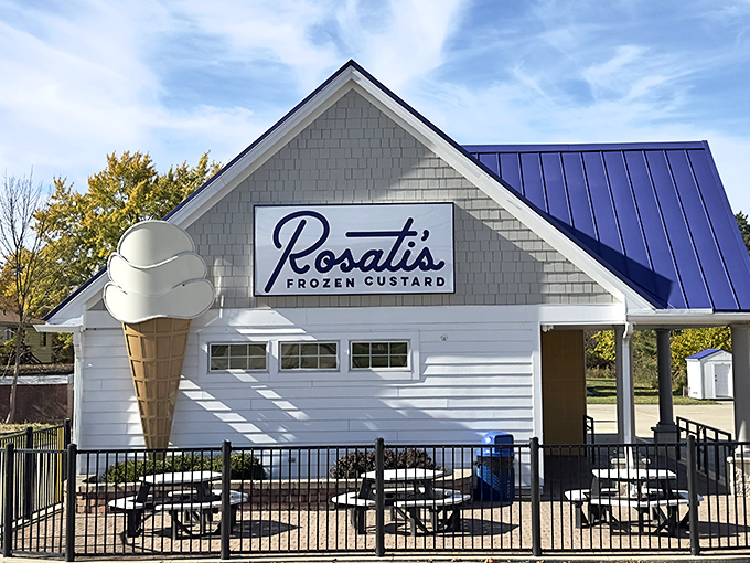 Rosati's glows like a frozen dessert lighthouse at dusk, its neon ice cream cone beckoning weary travelers toward sweet salvation.