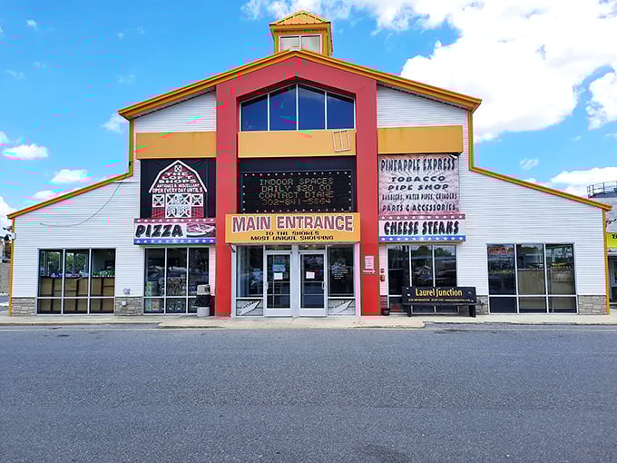 The unmistakable red and yellow facade of Laurel Junction Flea Market stands like a beacon for bargain hunters and culinary adventurers alike.