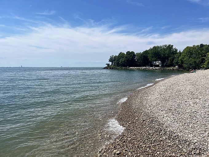 Lake Erie unfolds its blue canvas at Catawba Island State Park, where the pebble beach meets crystal-clear waters in a perfect Ohio postcard moment.