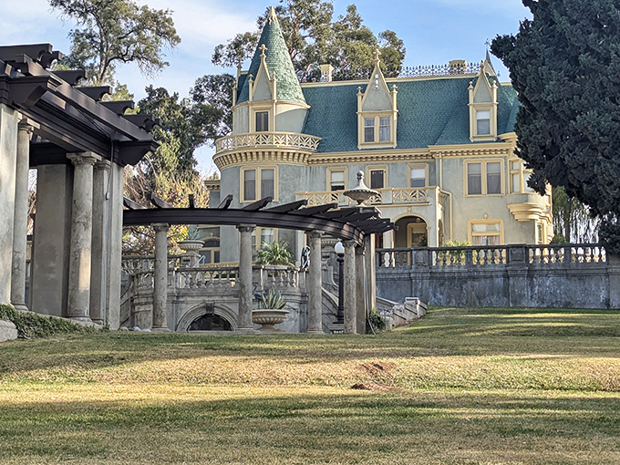 The blue-green mansard roof of Kimberly Crest rises like a Victorian dream against the California sky, proving fairytales aren't just for storybooks.