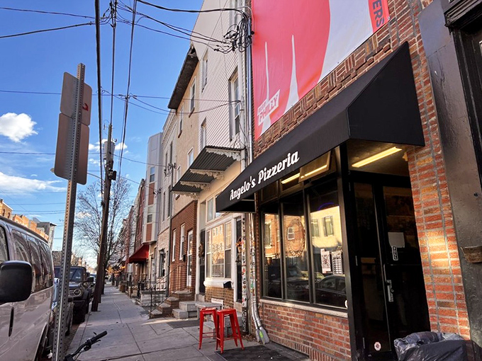 The unassuming storefront that houses culinary greatness. Angelo's Pizzeria's modest exterior belies the extraordinary food waiting inside, as evidenced by the perpetual line of devoted fans.