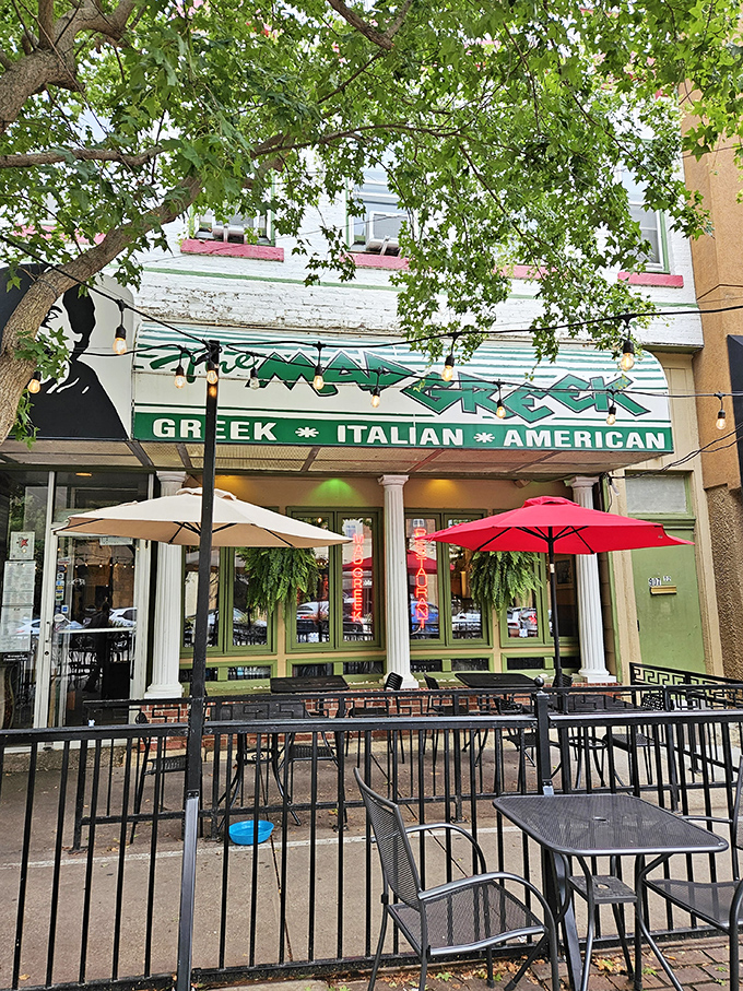 The Mad Greek's inviting storefront beckons with classic white columns and cheerful patio umbrellas&mdash;Massachusetts Street's little slice of Athens awaits your discovery.