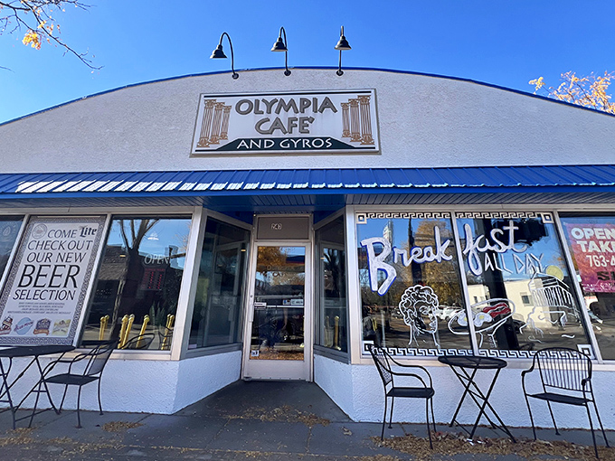 The blue-trimmed facade of Olympia Cafe beckons like a Mediterranean mirage in suburban Osseo, promising Greek delights and all-day breakfast adventures.