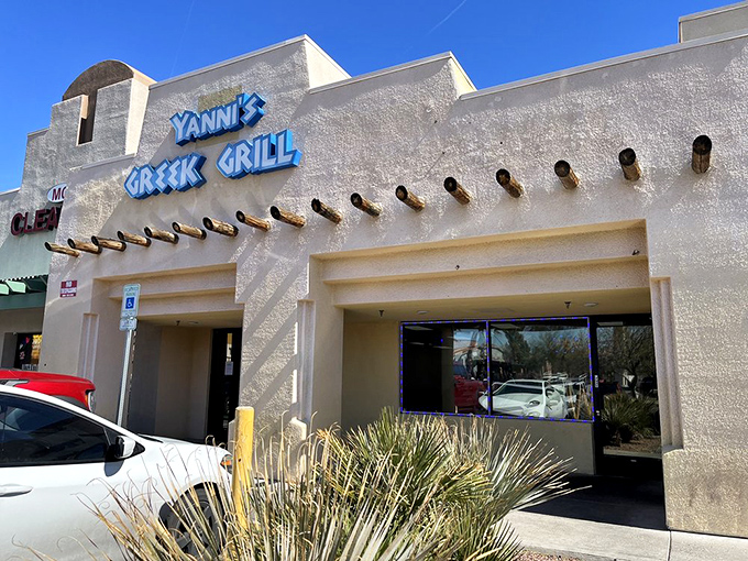 The unassuming exterior of Yanni's Greek Grill stands like a Mediterranean mirage in the Las Vegas desert, promising authentic flavors behind its blue signage.