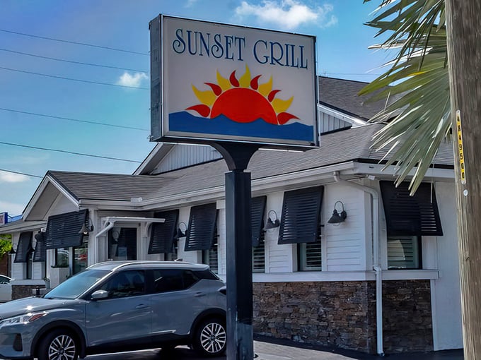 The iconic Sunset Grill sign welcomes hungry visitors with its cheerful sun logo, promising Florida warmth and hospitality before you even step inside.