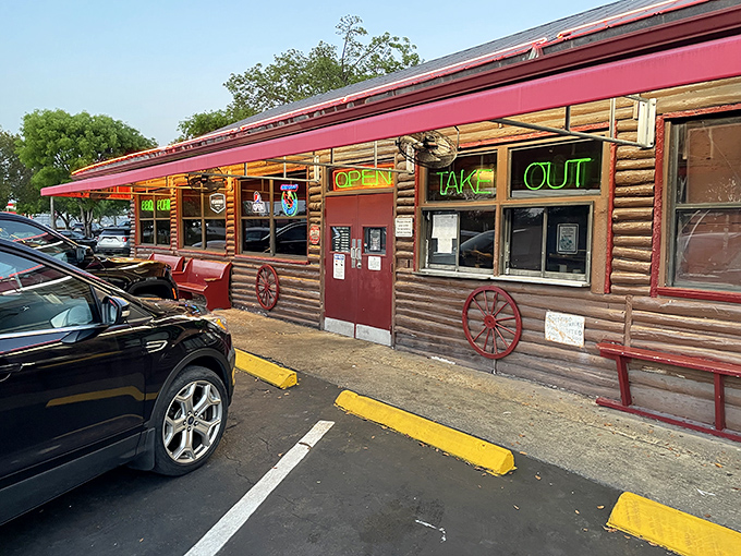 The iconic red roof and neon sign of Shiver's BBQ stands as a beacon of hope for hungry travelers at the edge of the Everglades.