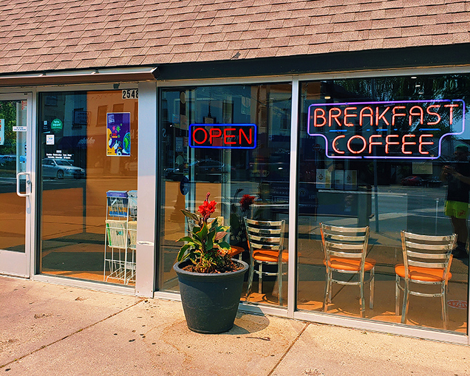 The neon promise of "BREAKFAST COFFEE" glows like a beacon for morning-starved souls. This unassuming storefront houses Minneapolis breakfast magic. 