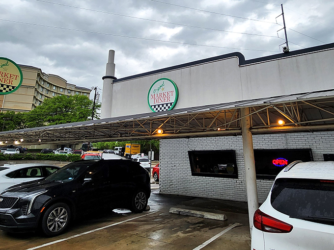 The iconic green and white signage promises comfort food salvation, standing defiantly against Dallas's modernizing skyline.