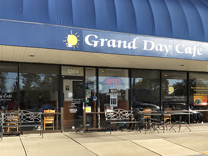 The blue awning of Grand Day Cafe beckons like a breakfast lighthouse guiding hungry souls to hash brown paradise. 